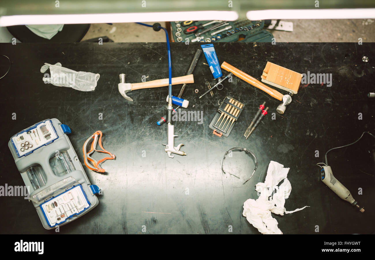 Tools on work bench in repair workshop, close up Stock Photo - Alamy