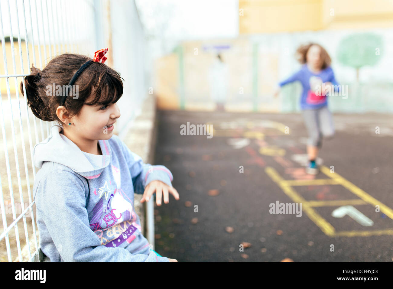 Portrait of smiling little girl playing outside Stock Photo - Alamy