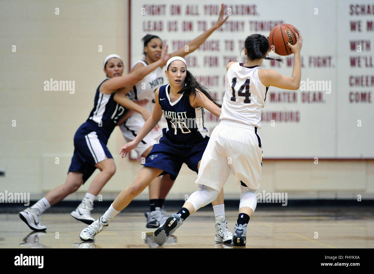 Defender forcing a dribbling opponent to cut off their drive during a ...