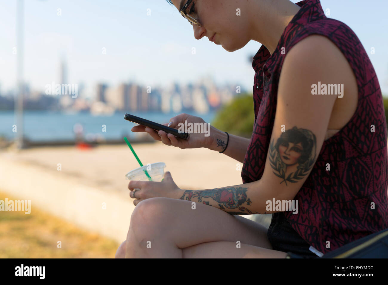 Tattoo woman sitting legs crossed hi-res stock photography and images ...