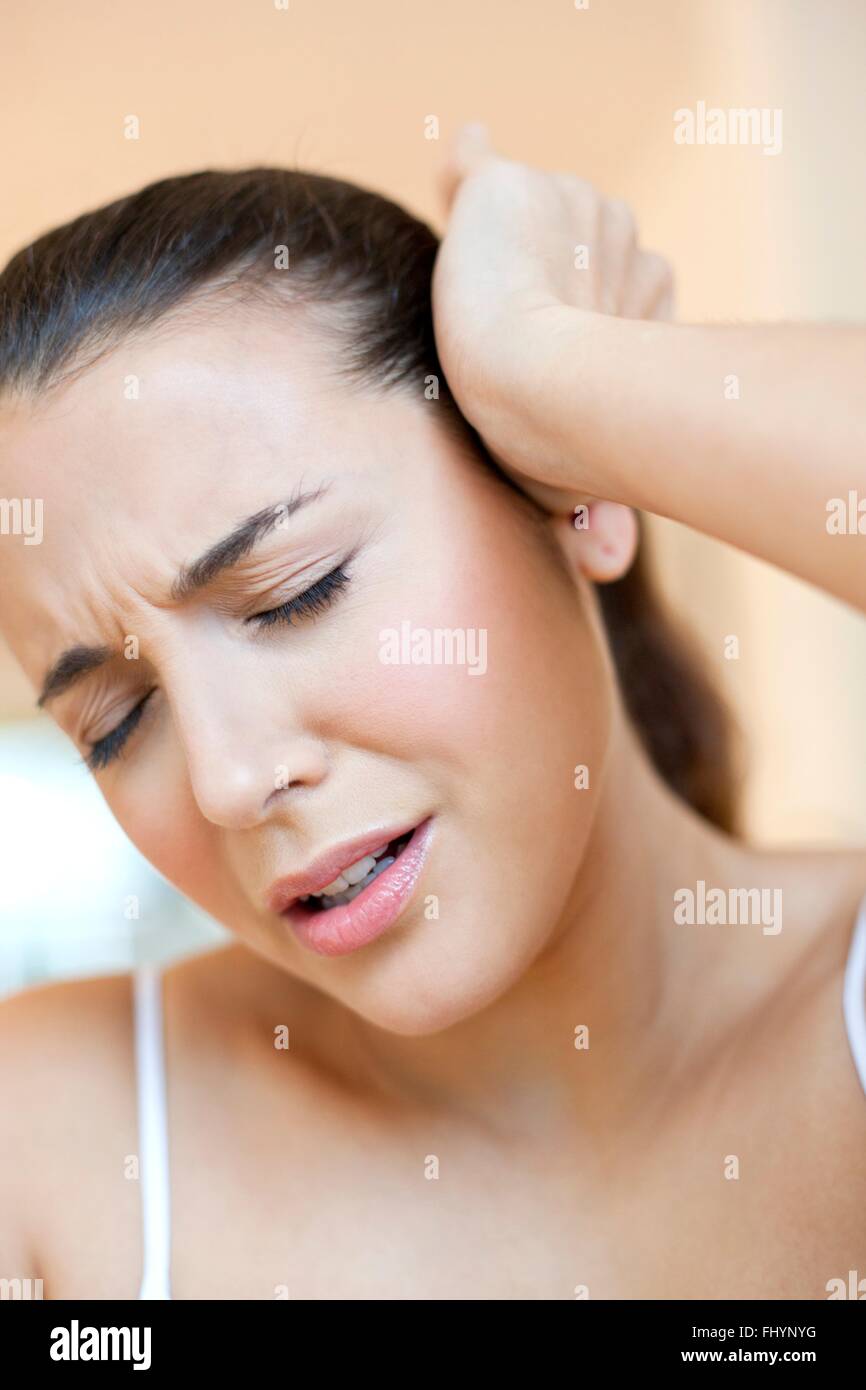 MODEL RELEASED. Woman touching her head with a headache Stock Photo - Alamy