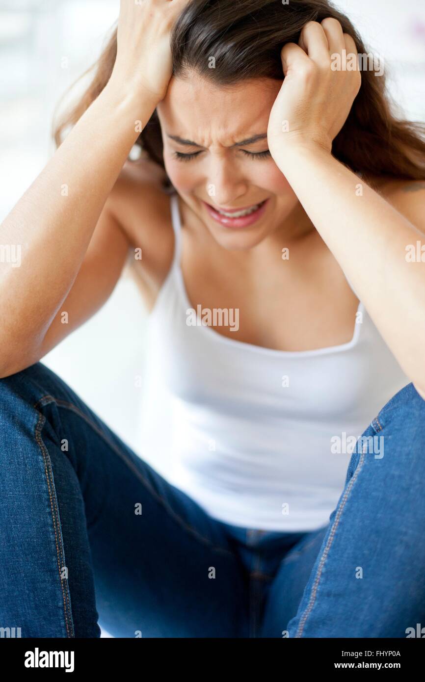 MODEL RELEASED. Woman with her hands in her hair Stock Photo - Alamy