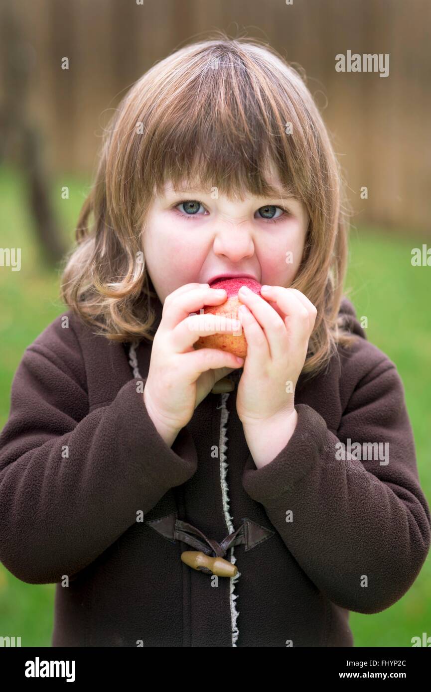 Child girl eating apple outside hi-res stock photography and images - Alamy