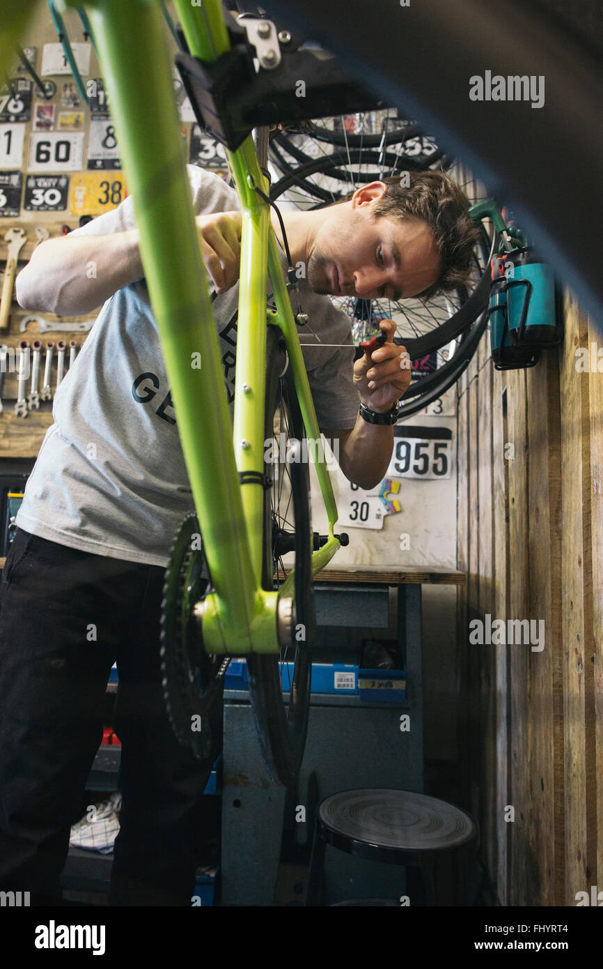 Mechanic working on bicycle Stock Photo - Alamy