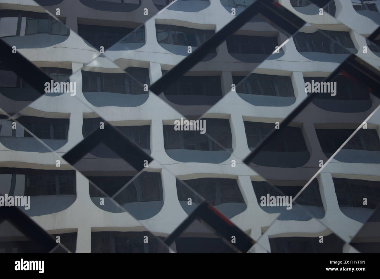 Reflections of skyscraper in mirrored glass building Stock Photo - Alamy