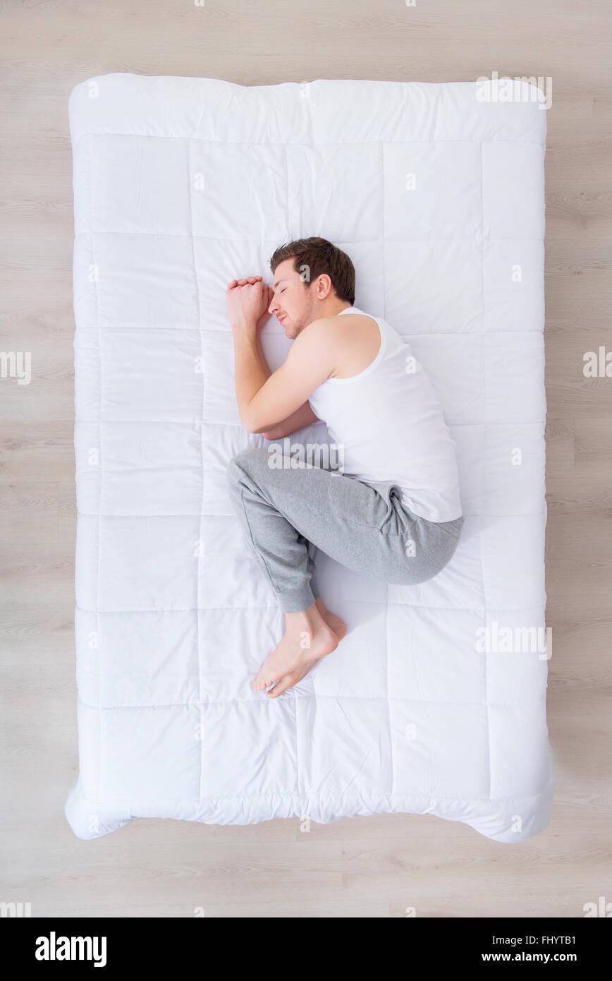 Handsome man sleeping in bed Stock Photo - Alamy