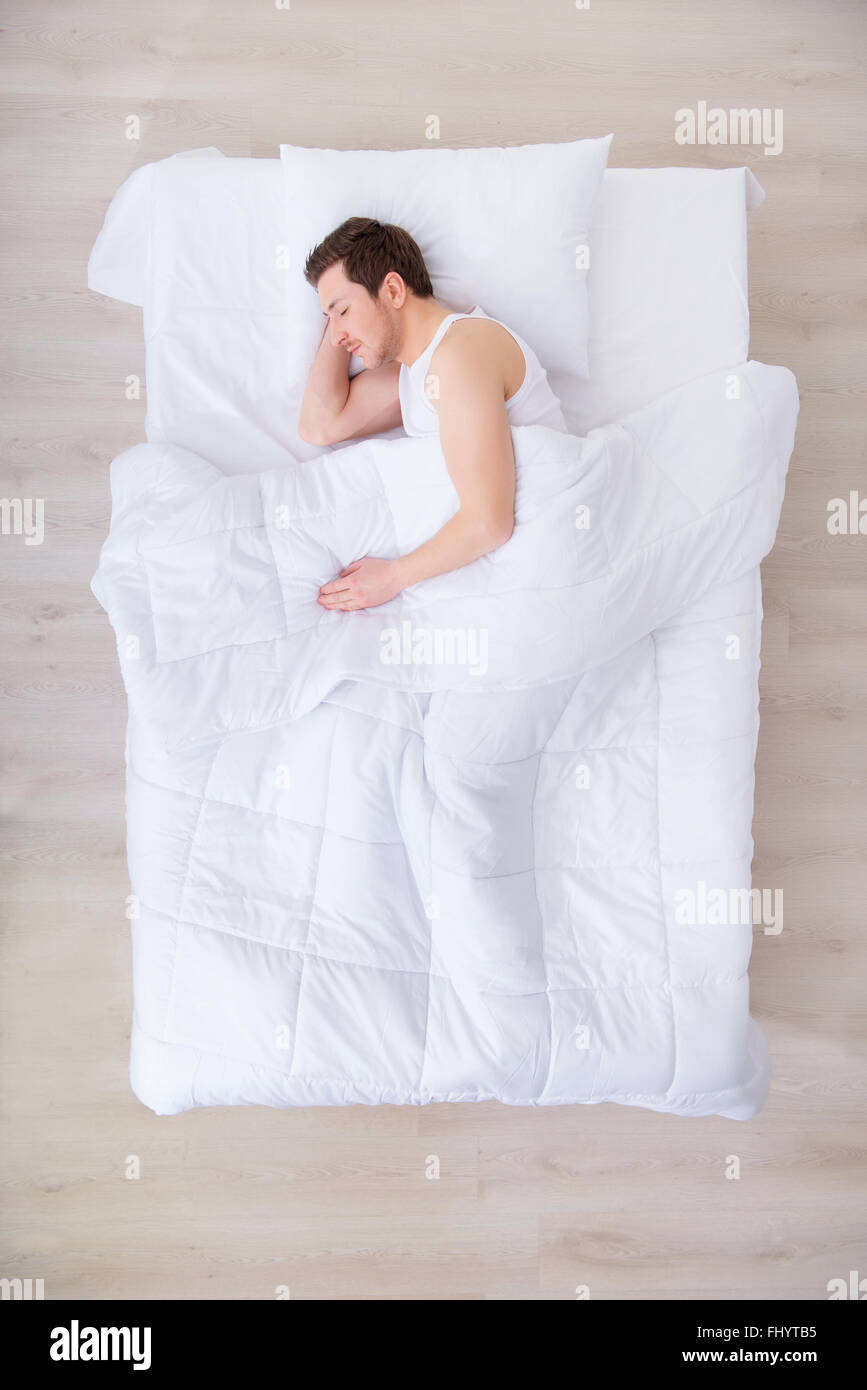 Nice man sleeping in bed Stock Photo - Alamy