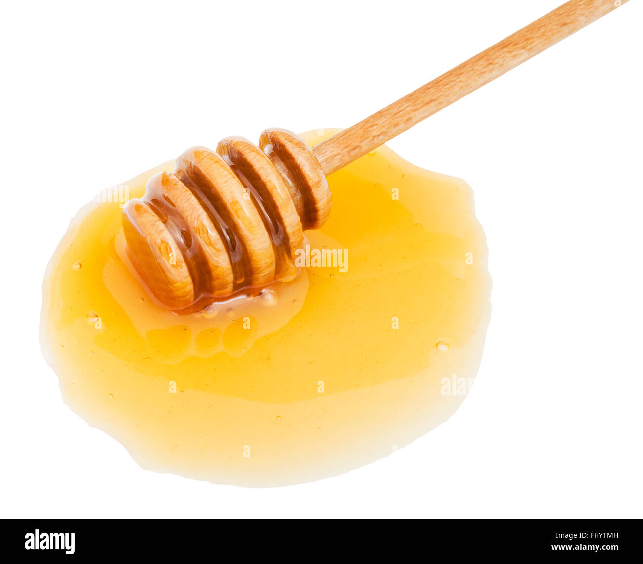 puddle of transparent honey and wooden stick close up isolated on white ...
