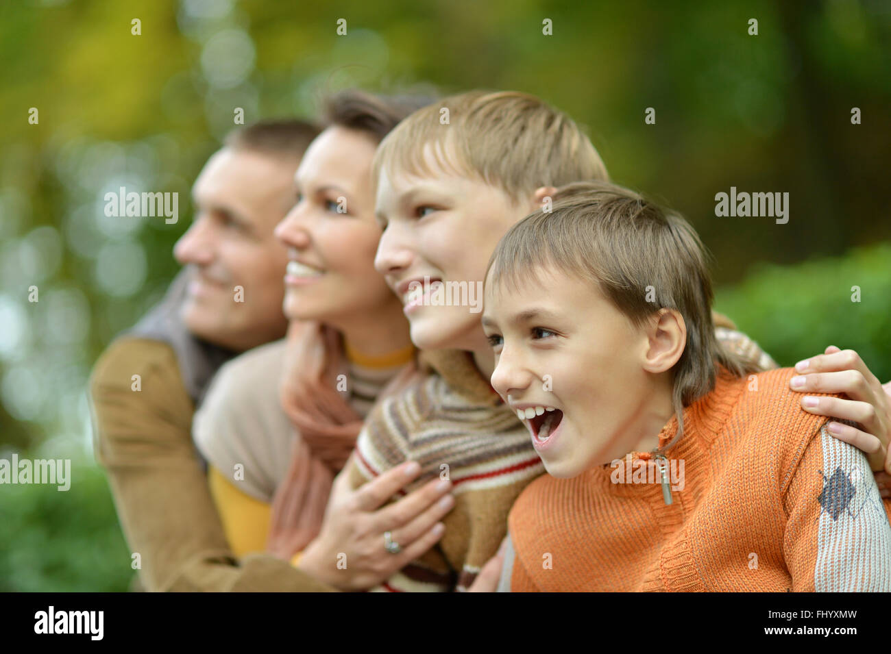 Happy family of four Stock Photo - Alamy