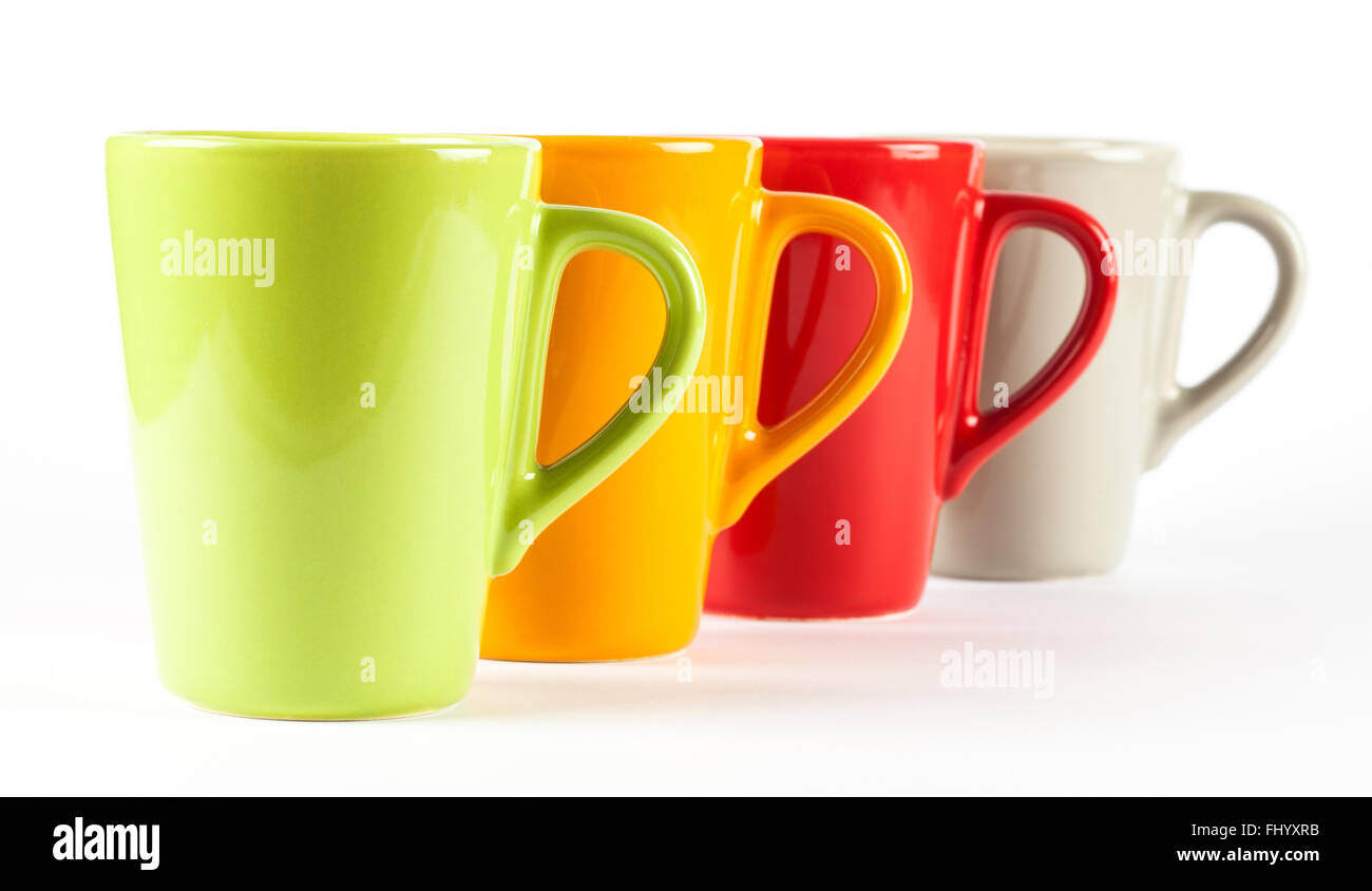 Four color tea cups shown in row white background Stock Photo - Alamy