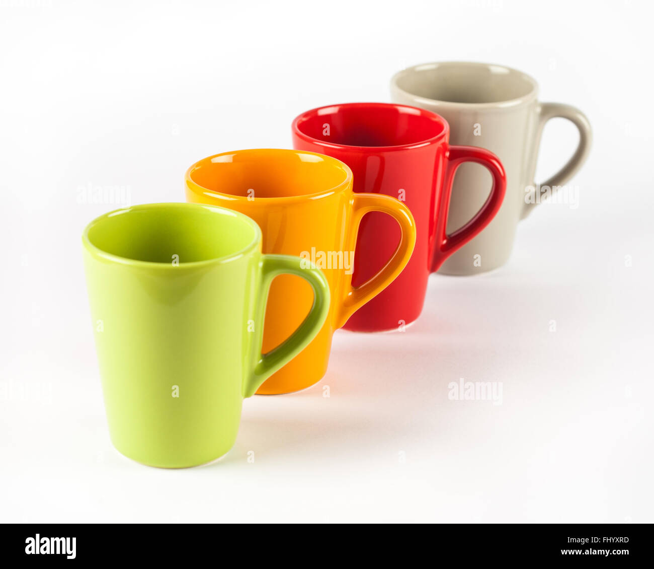 Four color tea cups shown in row white background Stock Photo - Alamy
