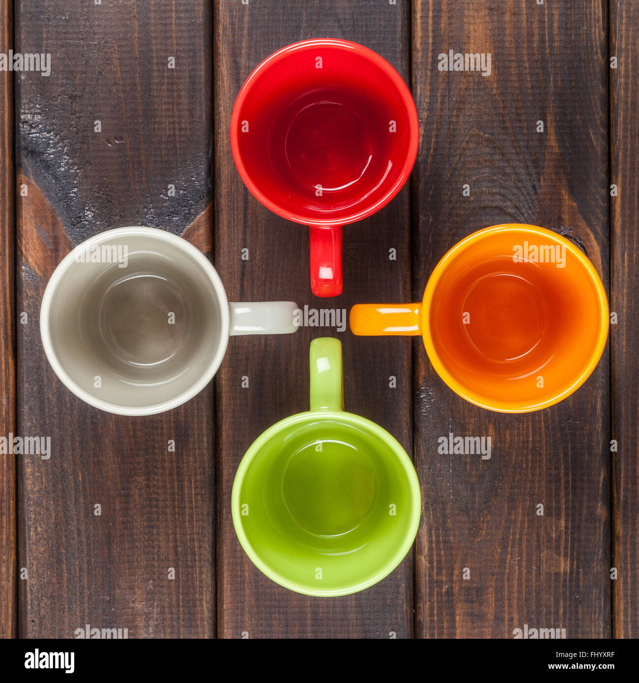 Four color tea cups arranged in a cross, top view Stock Photo - Alamy