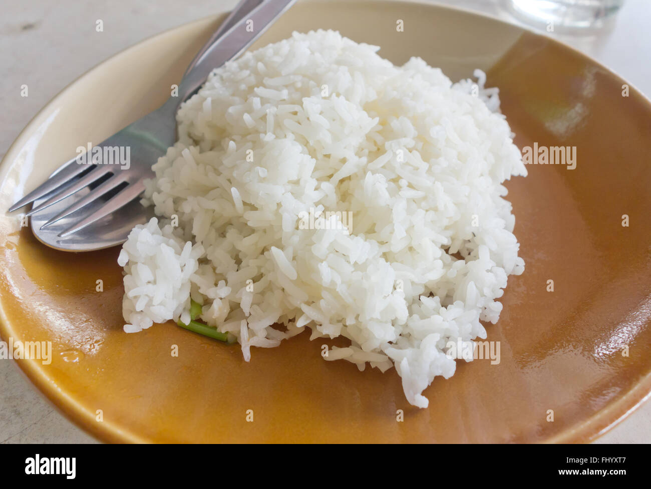steamed rice with spoon and fork Stock Photo - Alamy