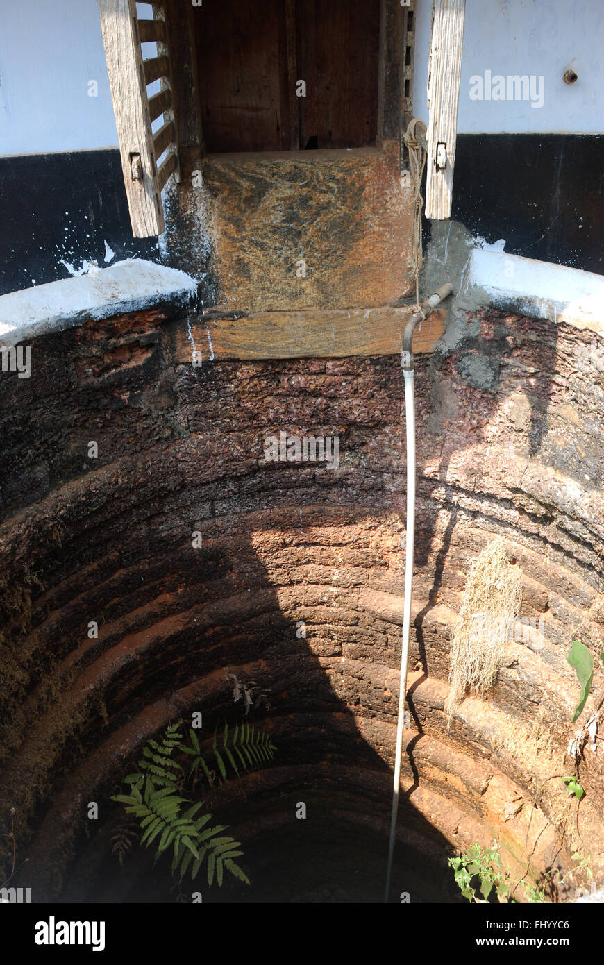 an old temple well constructed near window for fetching water ...