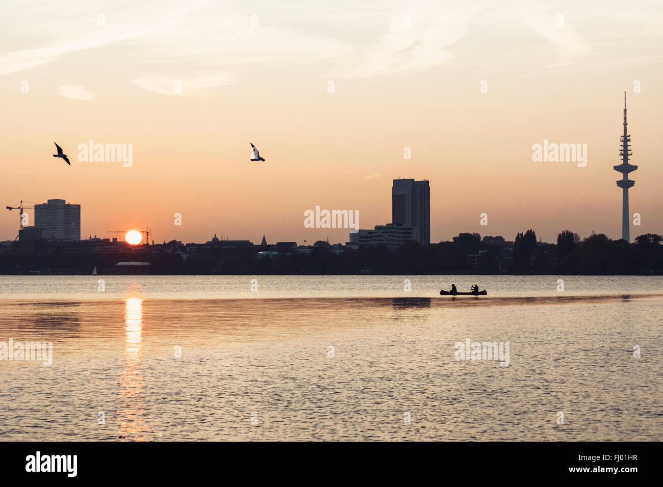 Germany, Hamburg, Outer Alster Lake at sunset, Heinrich-Hertz Tower ...