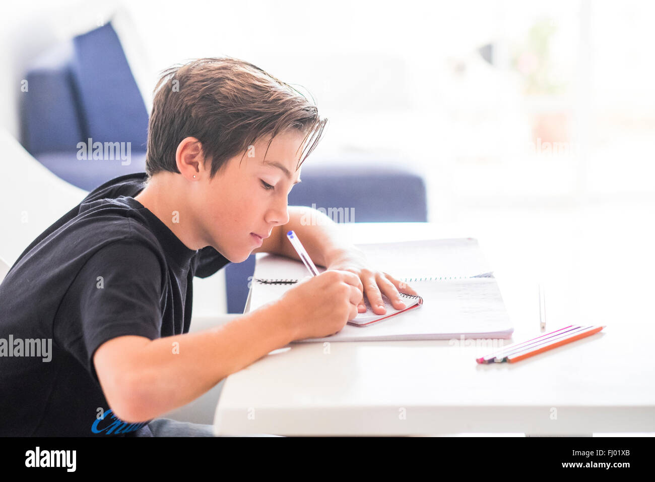Boy doing homework Stock Photo - Alamy
