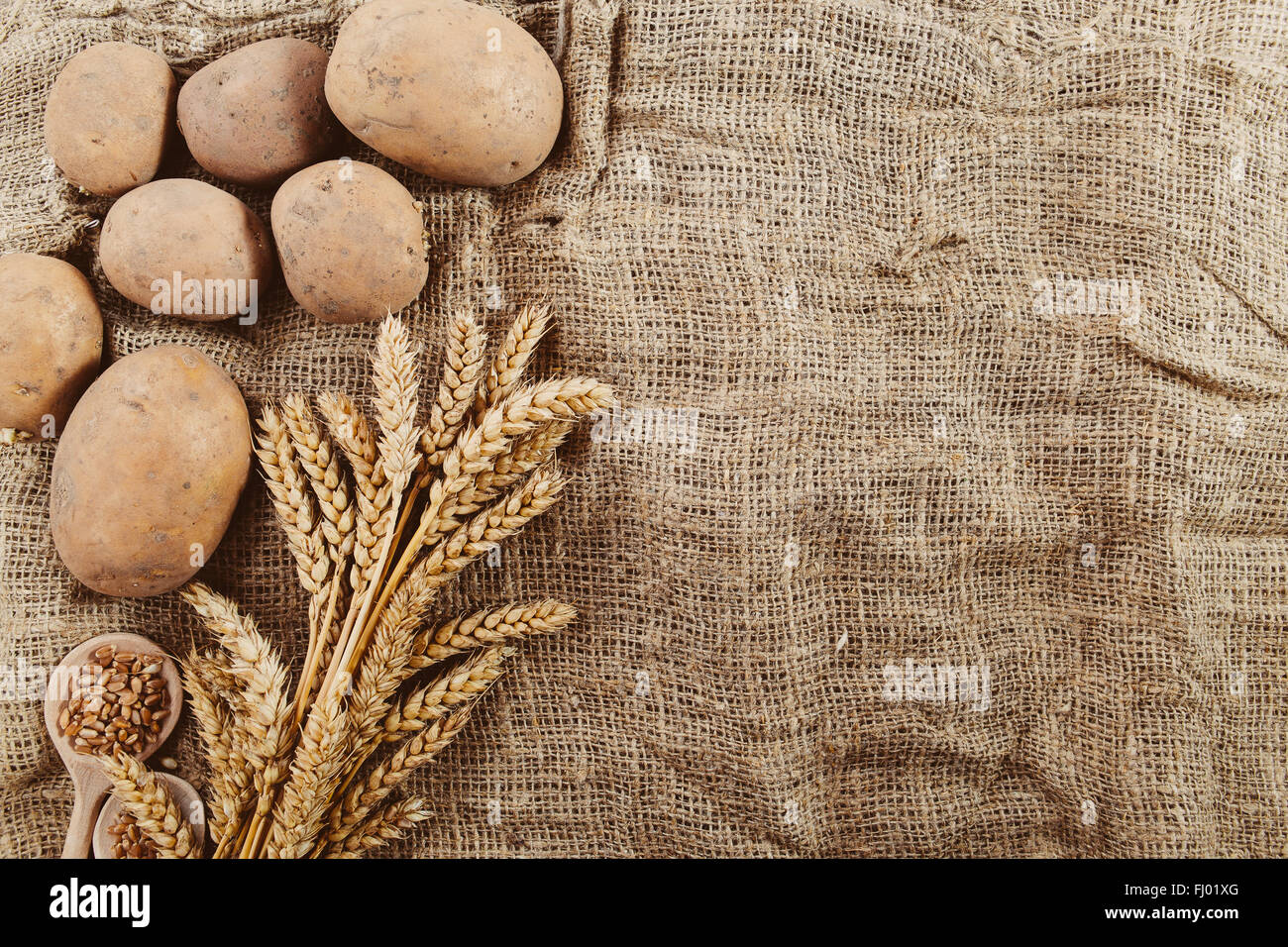 Wheat and potato on old textile background Stock Photo - Alamy
