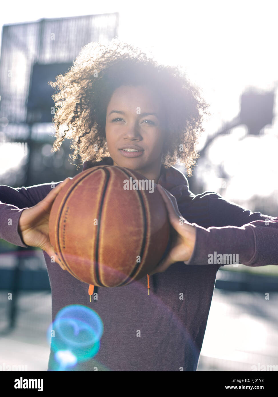 Portrait of young woman passing basketball at backlight Stock Photo - Alamy