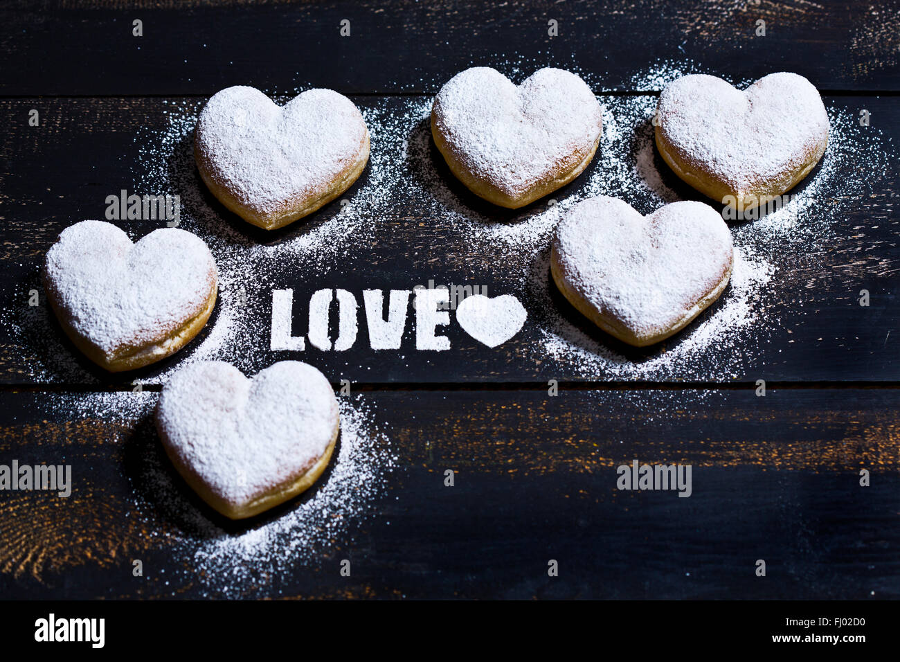 The word 'Love' stenciled with icing sugar and six heart-shaped ...