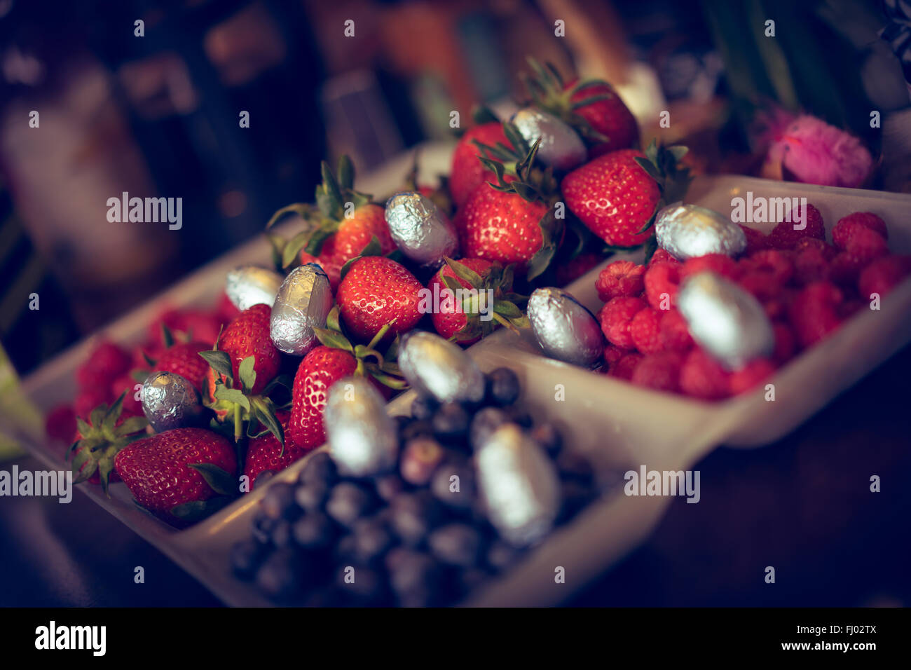 A selection of berries at Easter on a dining table with mini easter ...