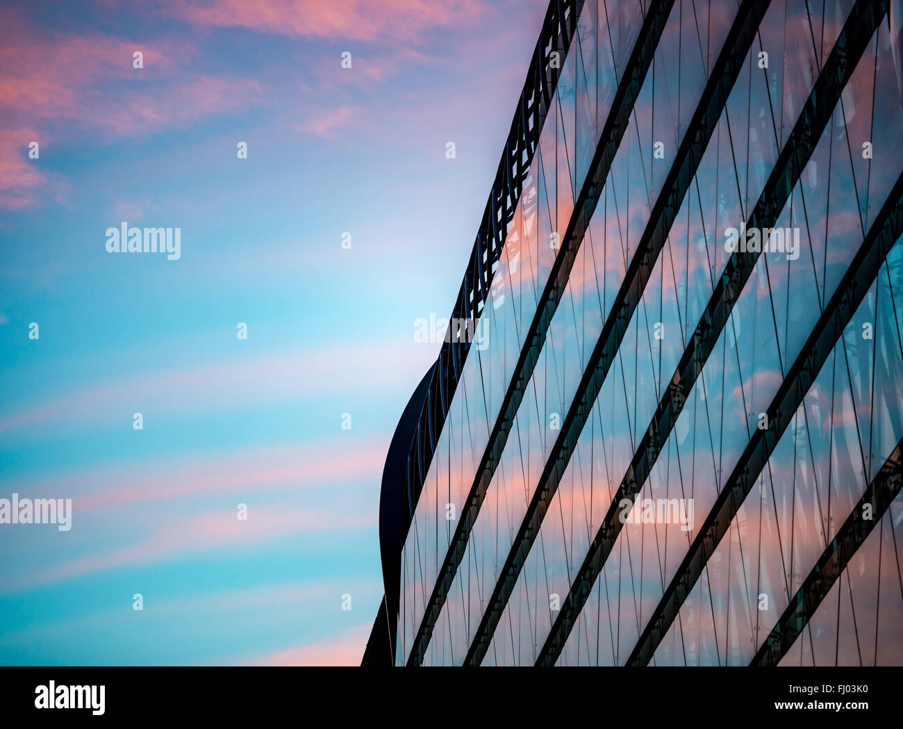 Sunset reflection in glass panels of modern building in Pest part of ...