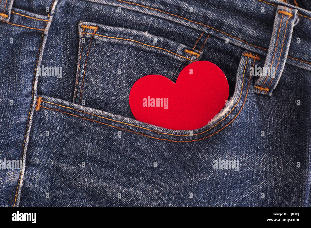 Red paper heart in a pocket of blue jeans. Close up Stock Photo - Alamy