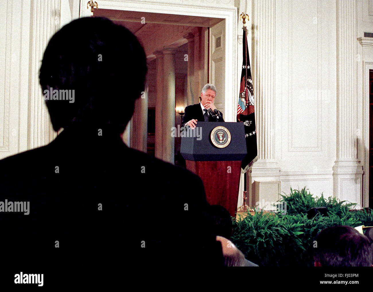 United States President Bill Clinton listens to a reporter's question ...