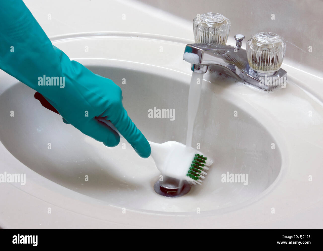 Gloved hand cleaning bathroom sink hi-res stock photography and images ...