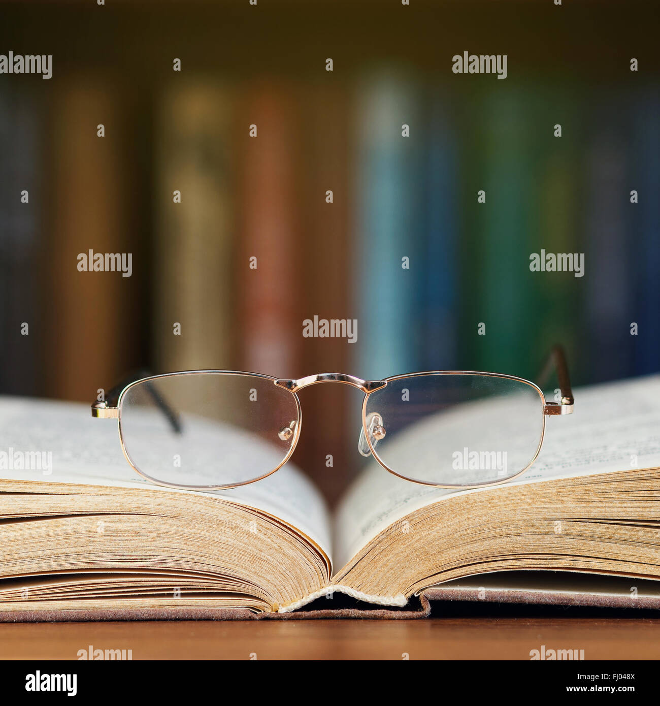 Glasses on a book Stock Photo - Alamy