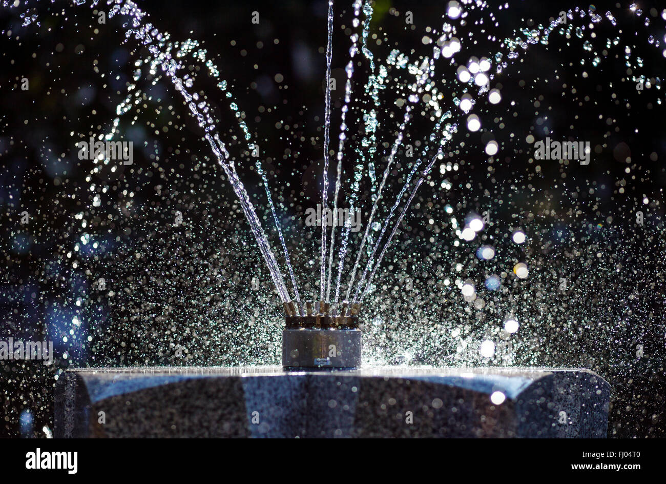 Water stream splashing on ground Stock Photo - Alamy