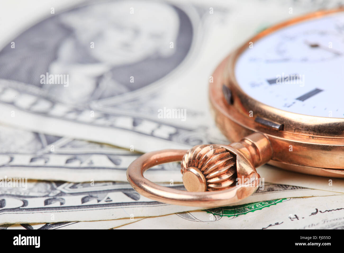 gold watch on dollar money banknotes. selective focus Stock Photo - Alamy