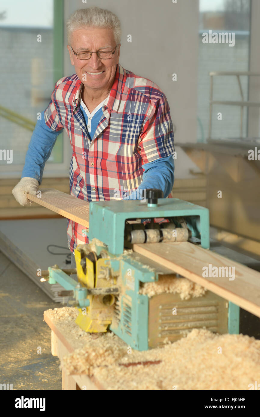 Senior man repairing in the room Stock Photo - Alamy