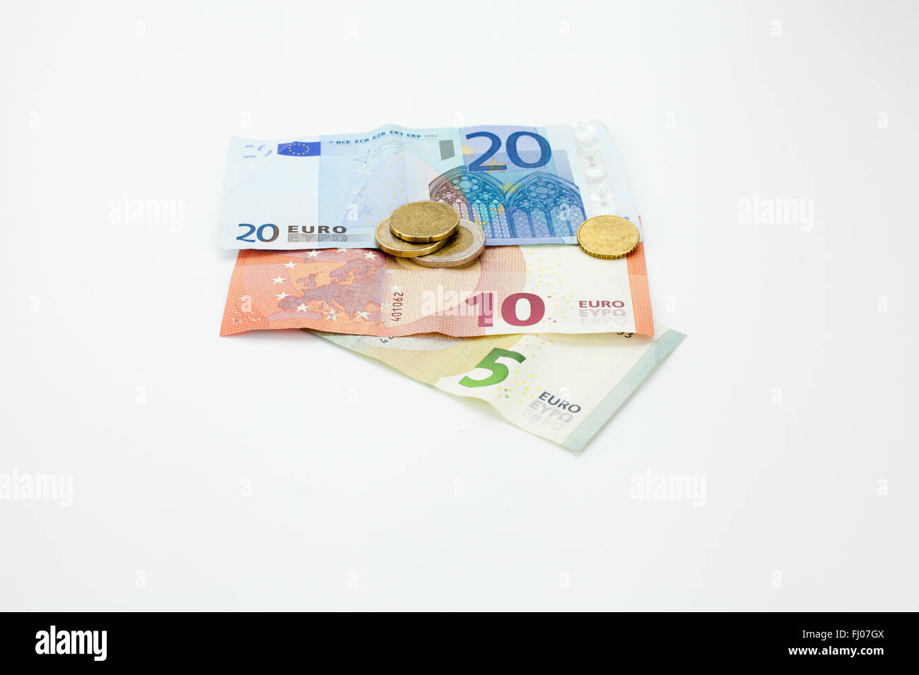 euro banknotes denomination and coins on white surface Stock Photo - Alamy