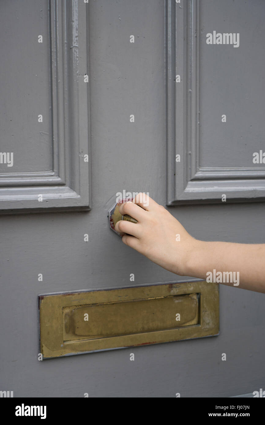 Woman's hand holding a door handle Stock Photo - Alamy