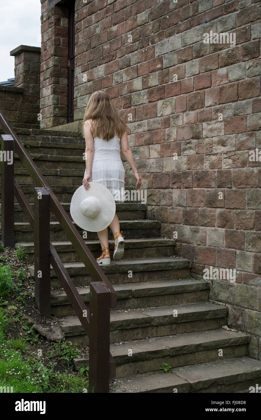 Woman climbing stairs hi-res stock photography and images - Alamy