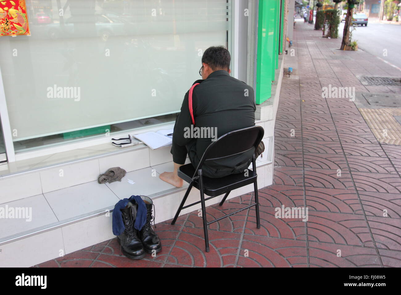 A local police officer rests in Bangkok, Thailand Stock Photo - Alamy