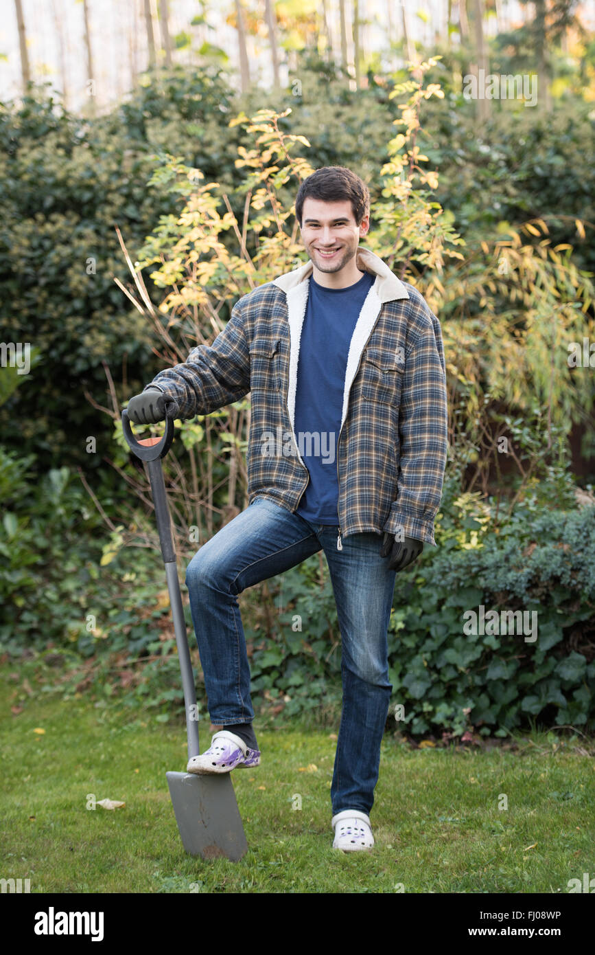 young man working in garden with shovel Stock Photo - Alamy