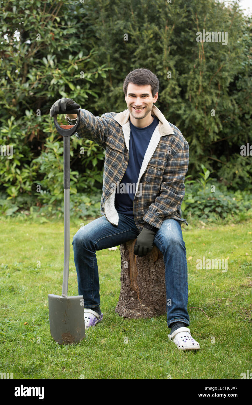 young man working in garden with shovel Stock Photo - Alamy