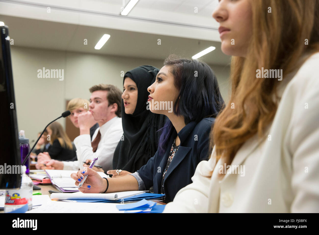High school teens serving as prosecutors in mock trial listen during ...