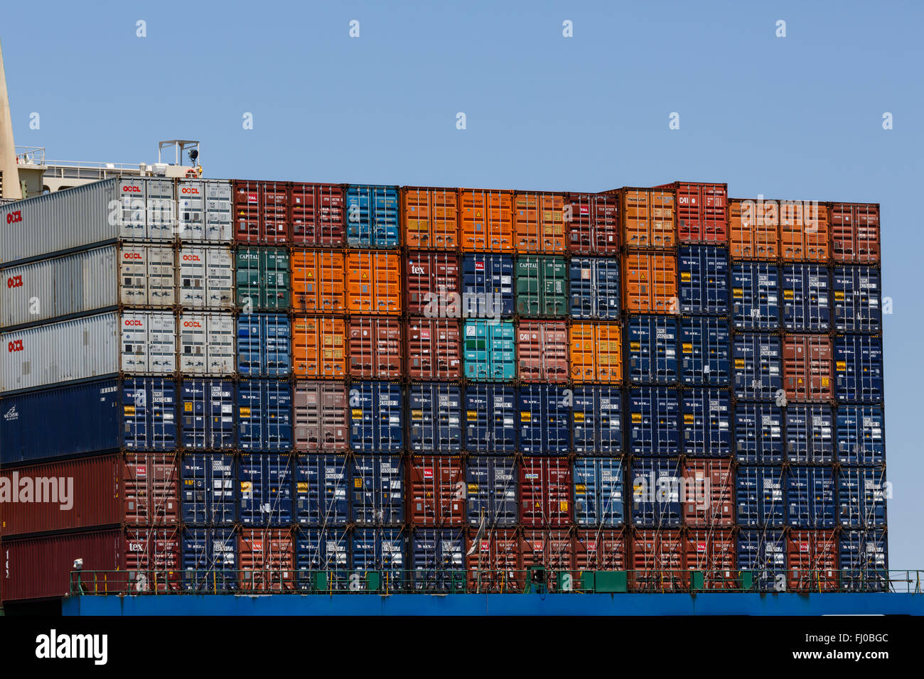 A cargo ship is loaded with shipping containers of various colors and ...