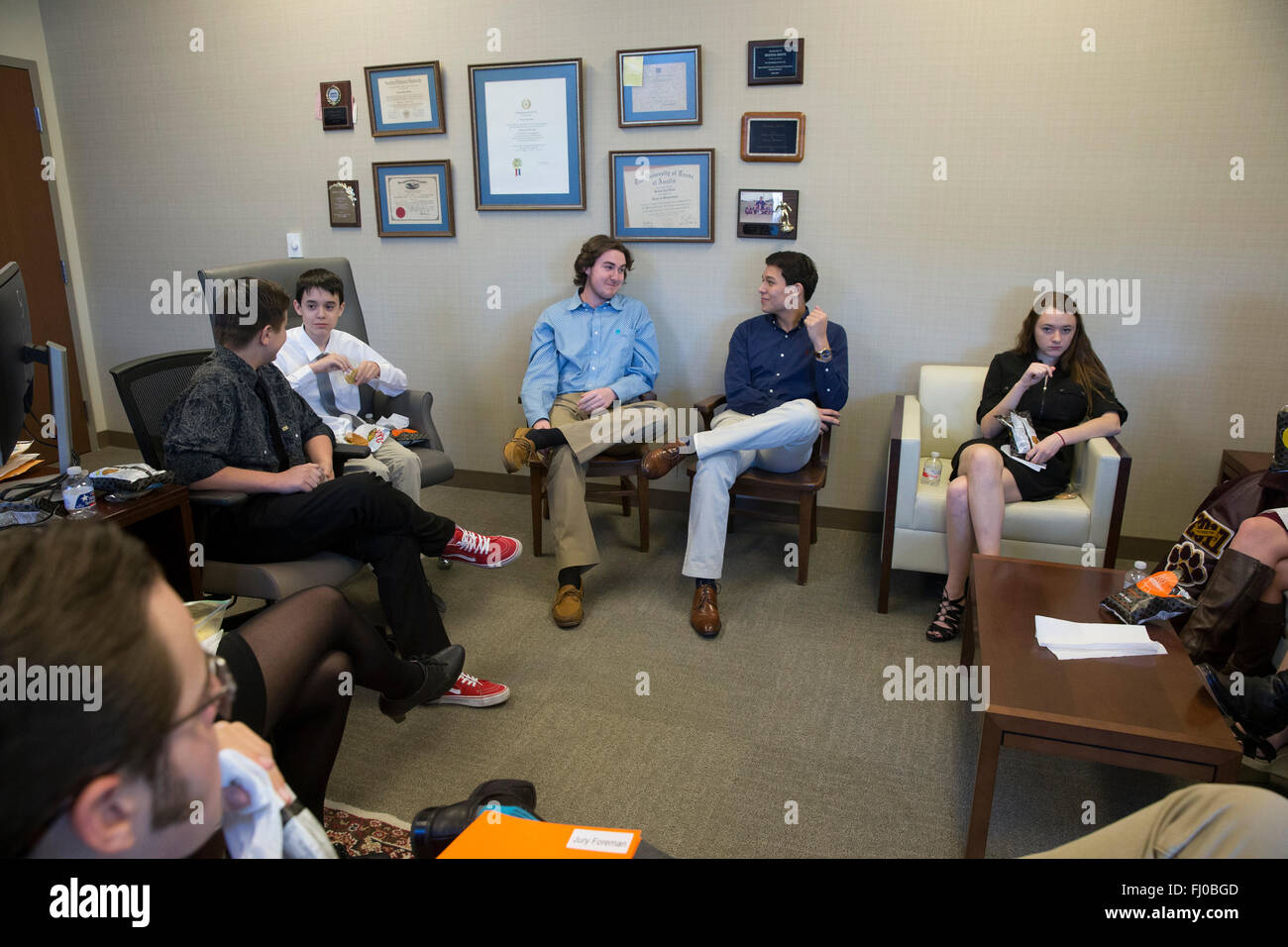 High school students serving as jurors in a mock trial discuss the case ...