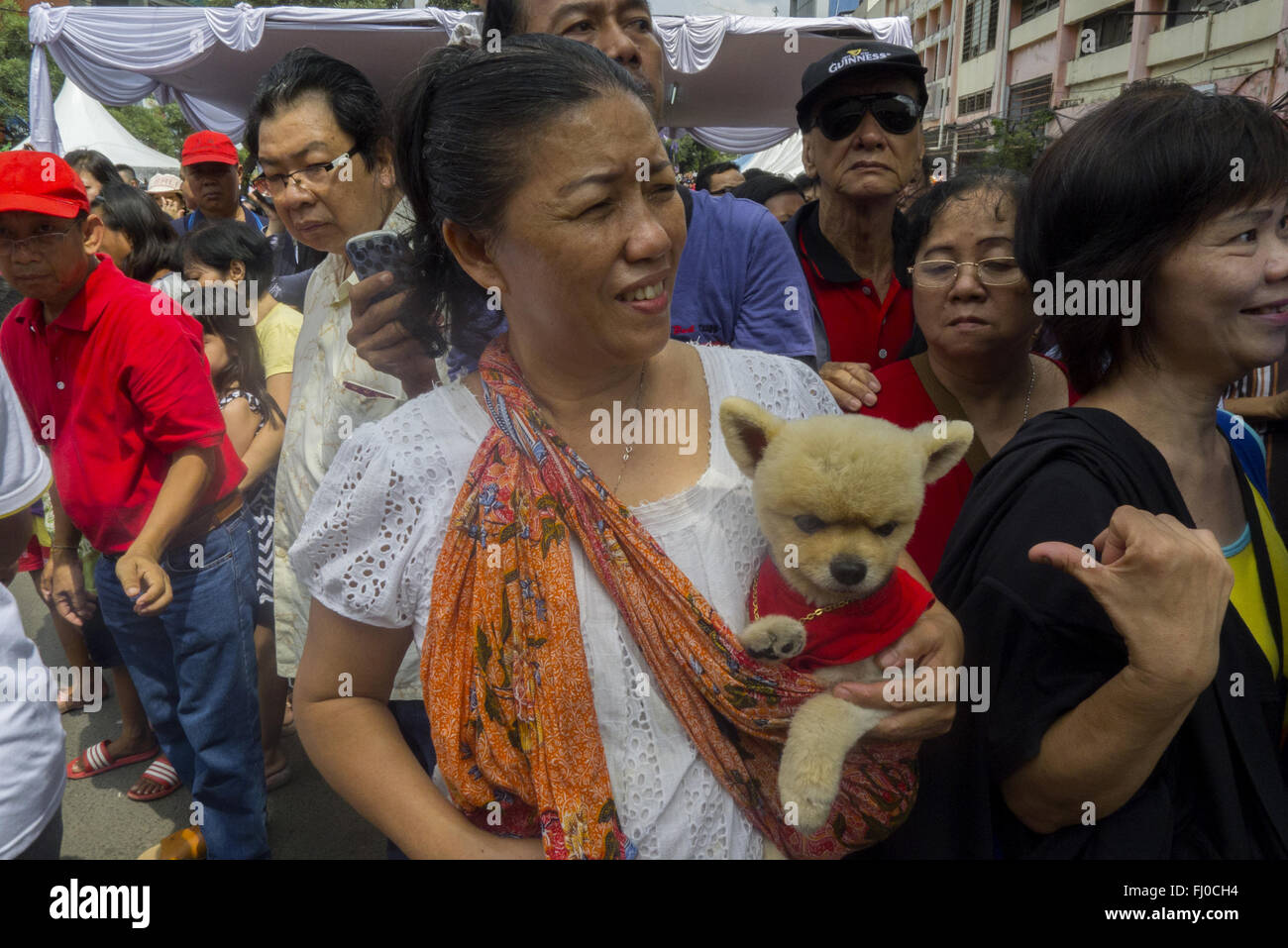 West Jakarta, Indonesia. 21st Feb, 2016. A citizen holding a pet dog ...