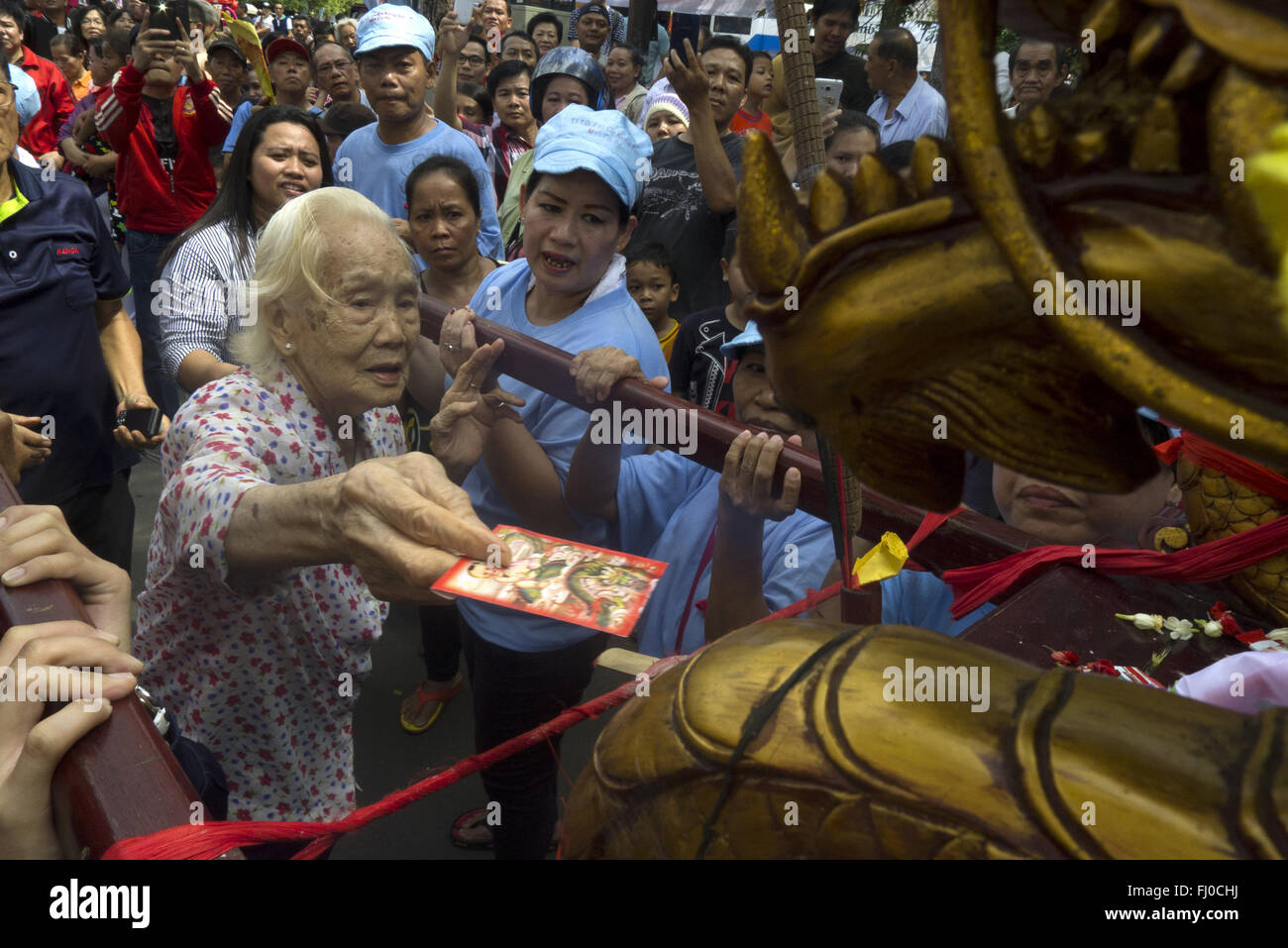 West Jakarta, Indonesia. 21st Feb, 2016. A grandmother gives angpao as ...