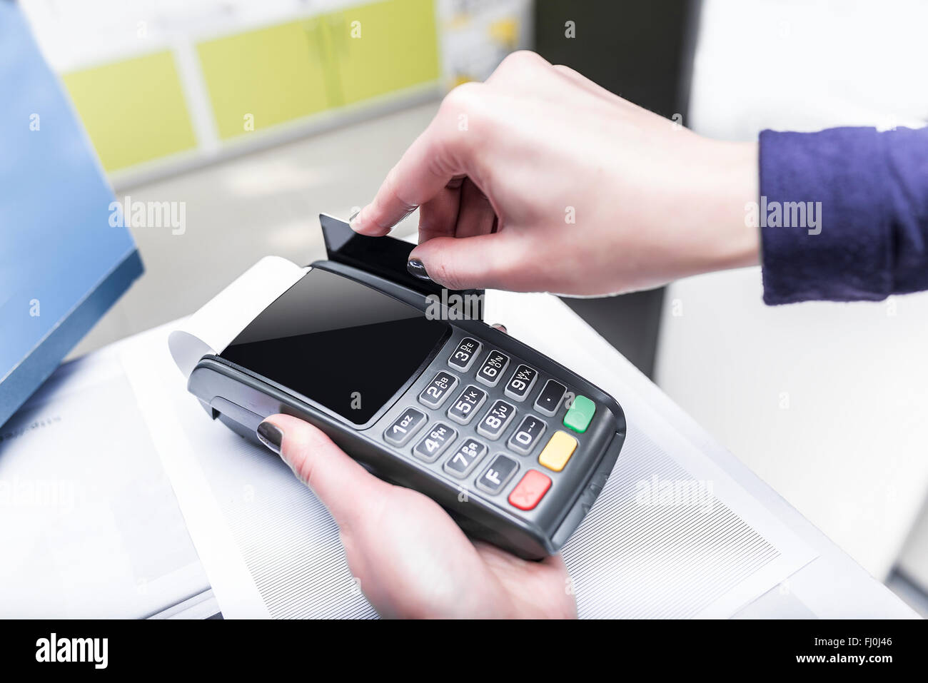 Debit card swiping on pos terminal Stock Photo - Alamy