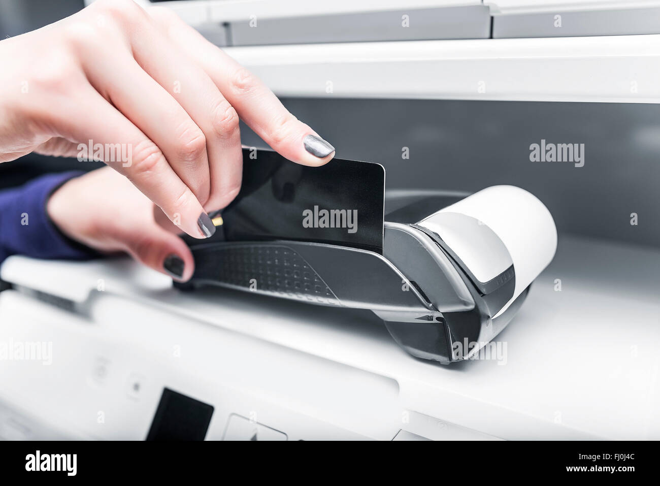 Debit card swiping on pos terminal Stock Photo - Alamy