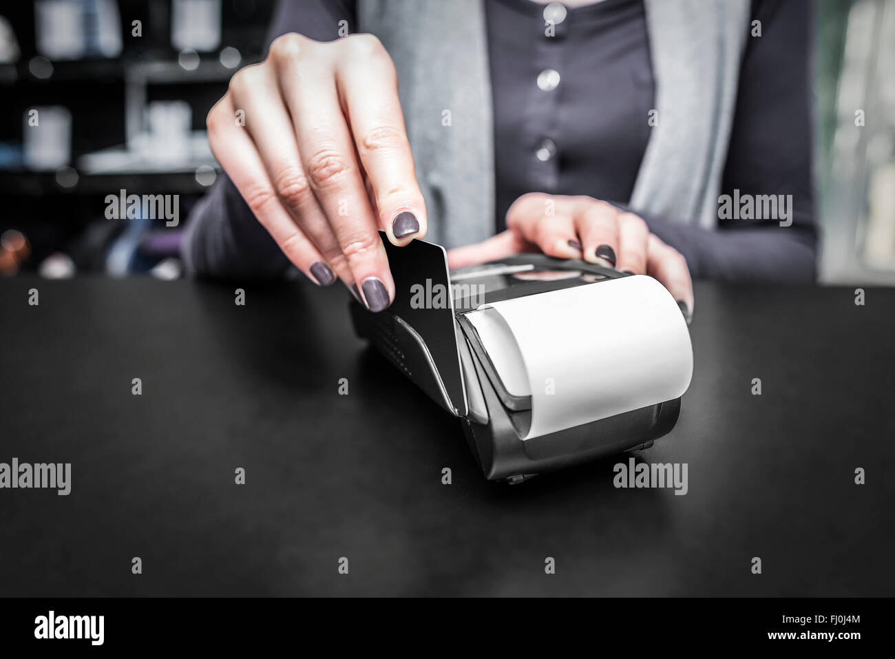 Debit card swiping on pos terminal Stock Photo - Alamy
