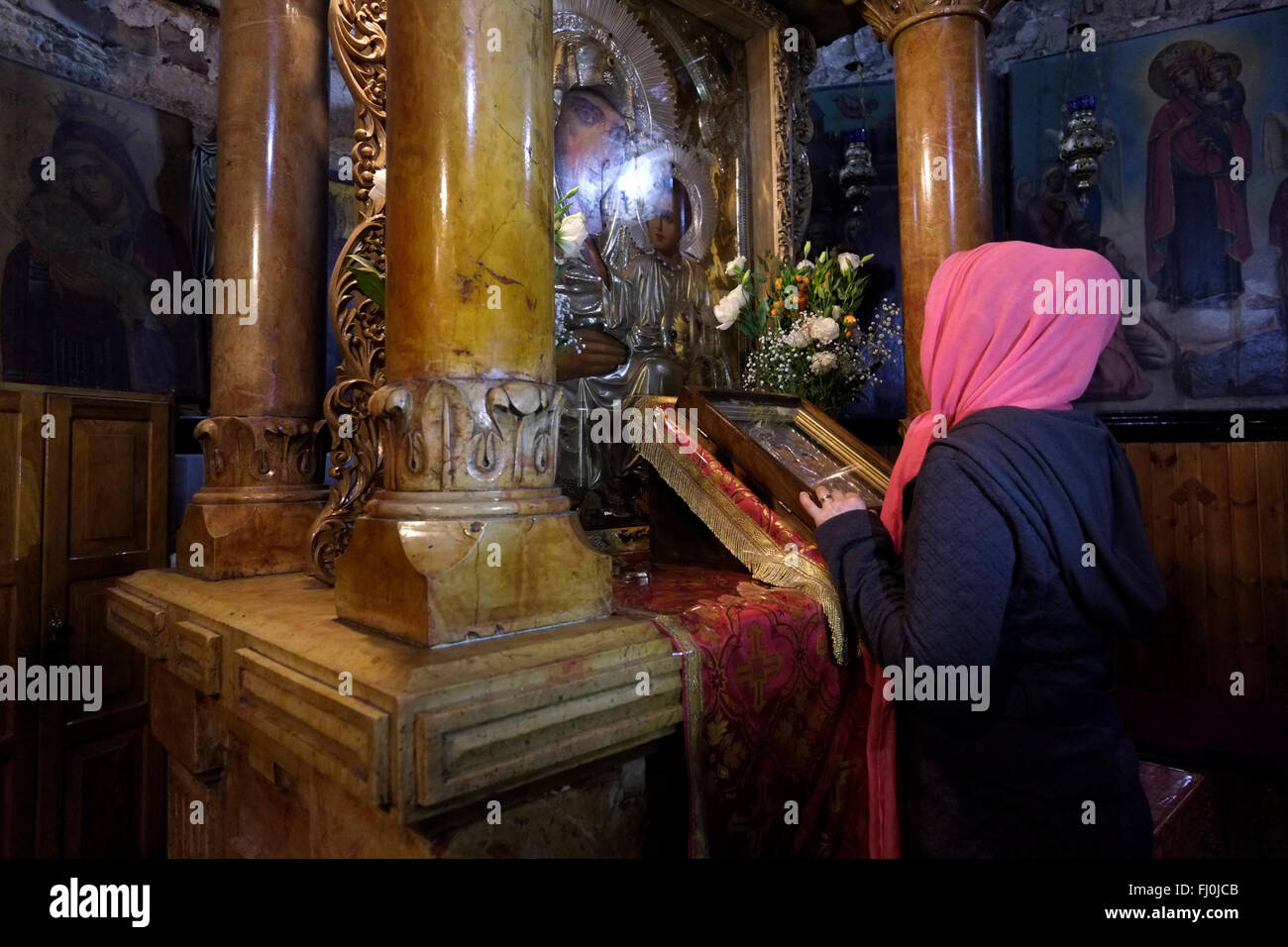 A Christian eastern Orthodox pilgrim praying inside the Church of the ...