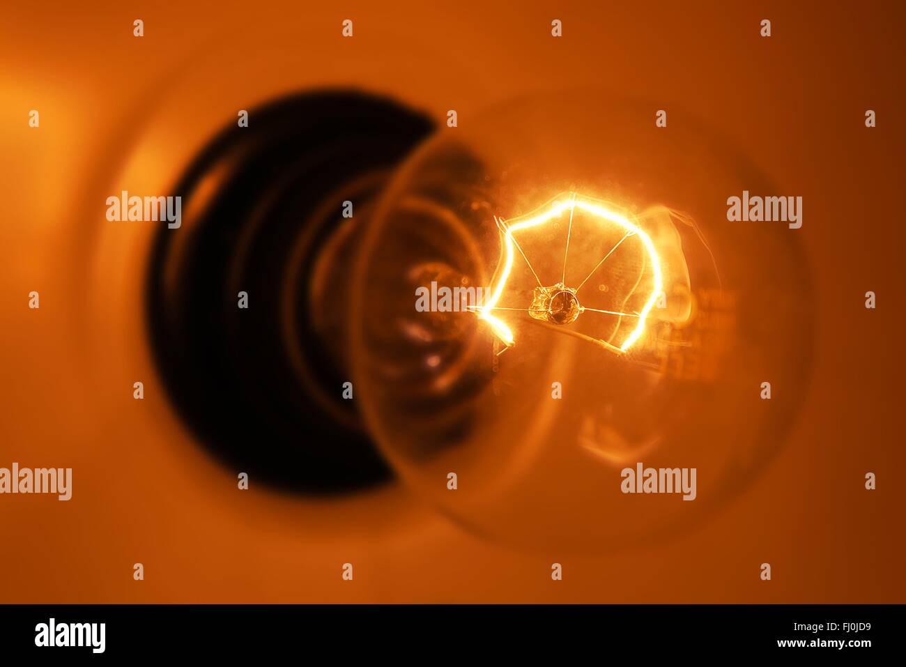 A lightbulb turned on, showing the glowing filament Stock Photo - Alamy