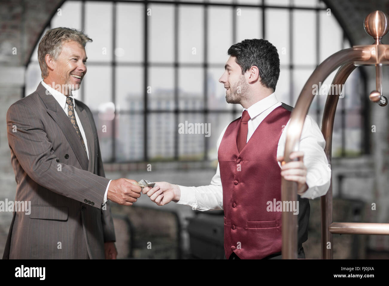 Man in hotel room with bellboy Stock Photo - Alamy