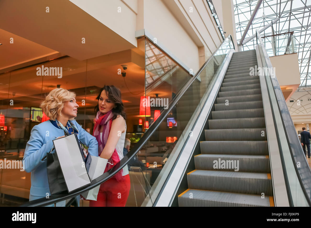 Young women shopping with pleasure Stock Photo - Alamy